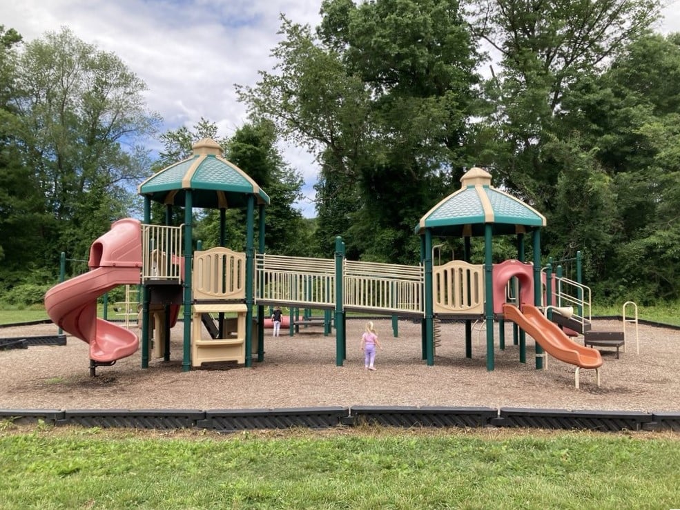 Playground paradise where kids burn energy while parents secretly wish the slides were adult-sized. Childhood as it should be.