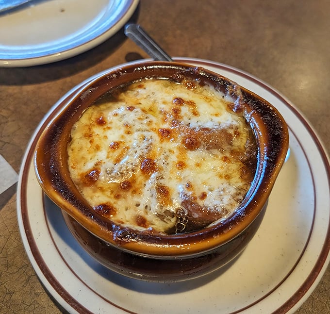 French onion soup arrives bubbling like a delicious volcanic eruption in your bowl. 