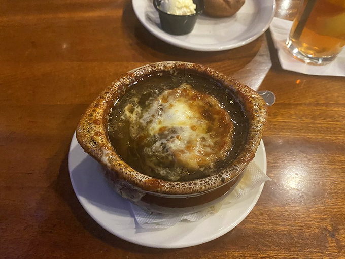French onion soup that's achieved the impossible trifecta: perfectly caramelized onions, rich broth, and a cheese cap that stretches for days.