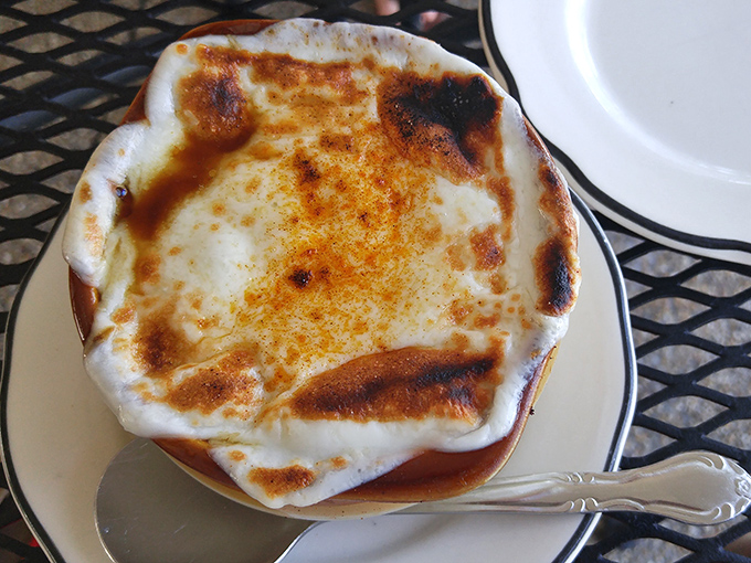 French onion soup wearing its cheese blanket like a cozy winter sweater you never want to take off.