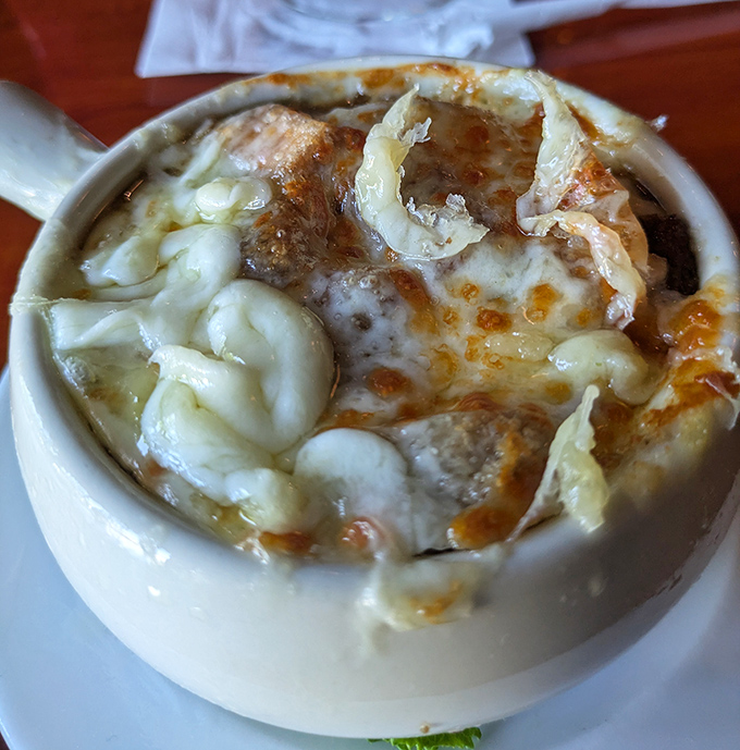 This isn't just French onion soup&mdash;it's a volcanic cheese eruption with sweet caramelized onions hiding beneath like delicious magma. Spoon-breaking cheese pull guaranteed.
