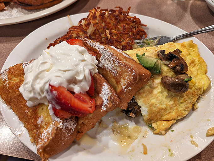 French toast topped with fresh strawberries and whipped cream &ndash; because sometimes breakfast should feel like dessert.