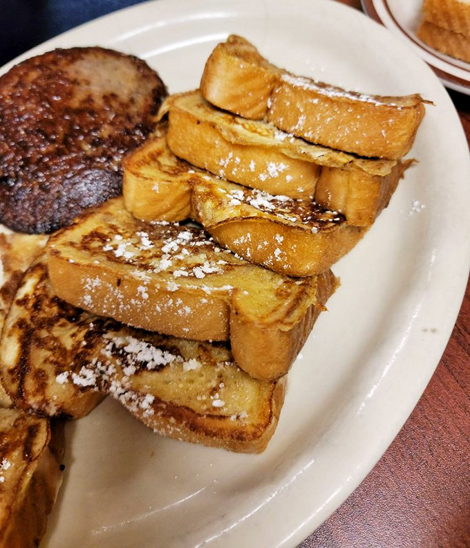 French toast that makes you question every other breakfast you've ever had. Dusted with powdered sugar like the first perfect snowfall of winter.