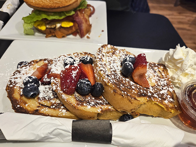 French toast that makes you question every other breakfast you've ever had. Those berries aren't just garnish&mdash;they're supporting actors in a culinary masterpiece.