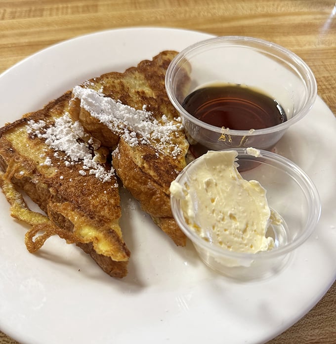 French toast that doesn't need a fancy culinary degree – just the perfect golden crust, a dusting of powdered sugar, and real maple syrup.