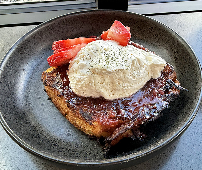 French toast that makes pancakes jealous. Brioche soaked in hoja santa custard with berries that pop like tiny flavor bombs.