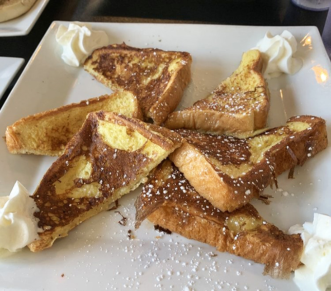 French toast triangles dusted with powdered sugar&mdash;like breakfast wearing its Sunday best, ready for your fork's first dance.