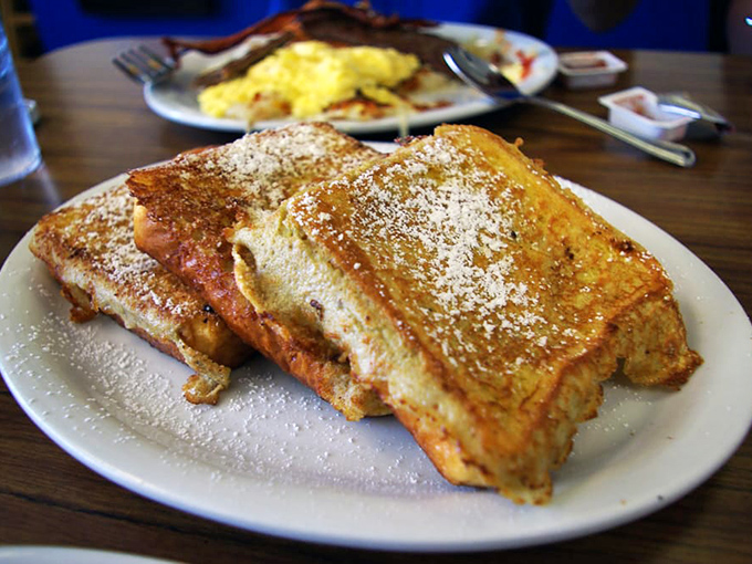 French toast that's dressed for success with a dusting of powdered sugar. It's breakfast masquerading as dessert, and nobody's complaining.