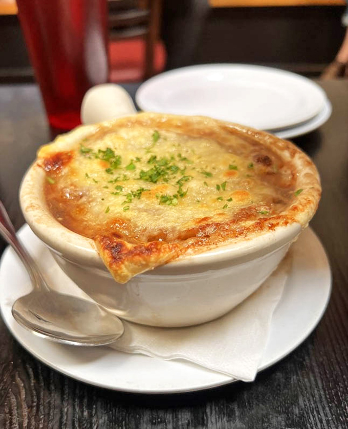 French onion soup that's had a proper education&mdash;deeply caramelized onions beneath a golden canopy of bubbling cheese.