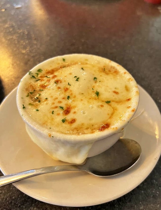 French onion soup that's wearing a golden crown of bubbling cheese. It's like comfort in a crock&mdash;the kind that makes you want to hug the chef. 