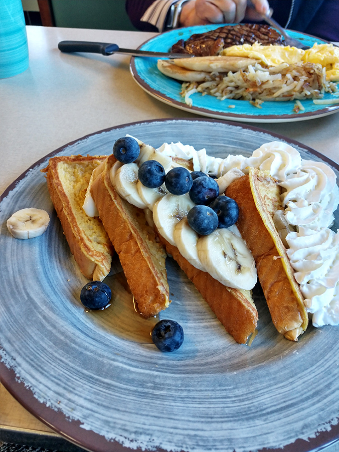 French toast that dreams are made of, topped with fresh blueberries and bananas &ndash; a sweet symphony that maple syrup conducts perfectly.