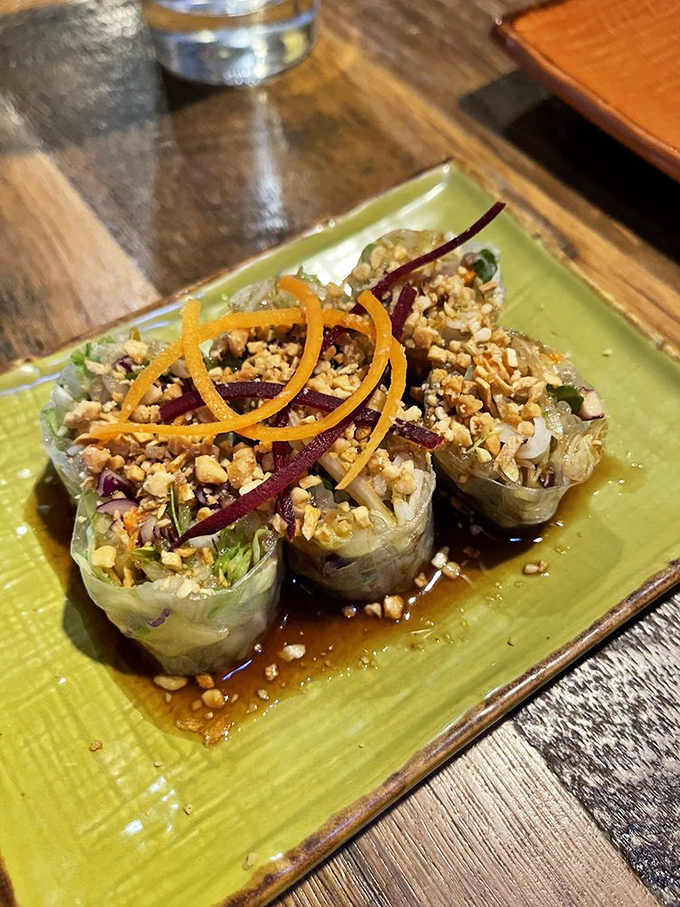 Fresh spring rolls that look like edible jewel boxes, topped with crushed peanuts and julienned vegetables. Transparency in food form&mdash;what you see is what you get.