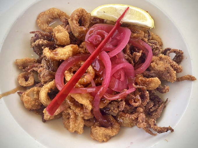Fried calamari with pickled onions &ndash; crispy, tender rings of joy that disappear faster than you can say "one more order, please."