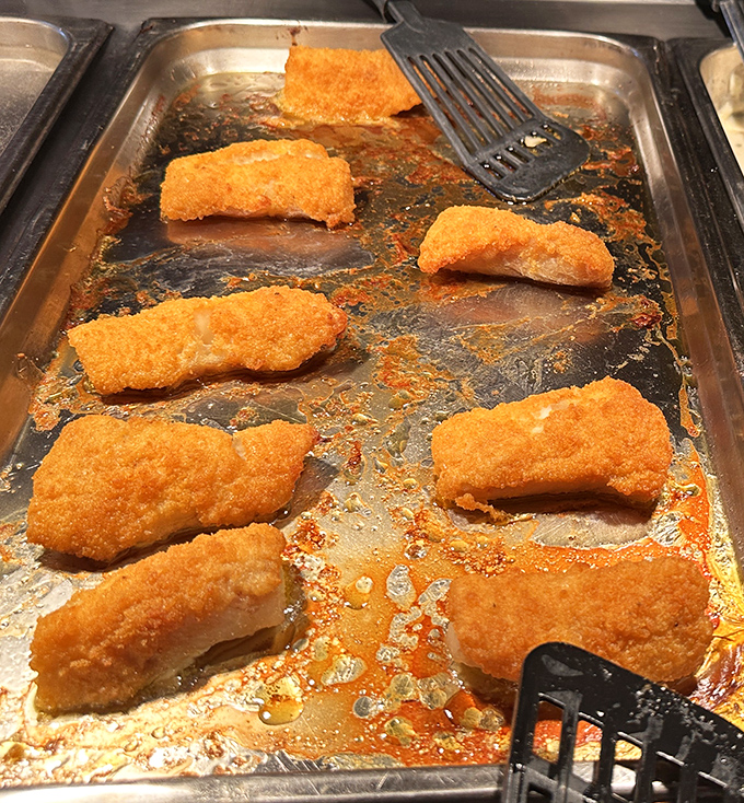 These golden-battered catfish fillets aren't just fried—they're transformed into crispy vessels of flaky perfection waiting to be discovered.