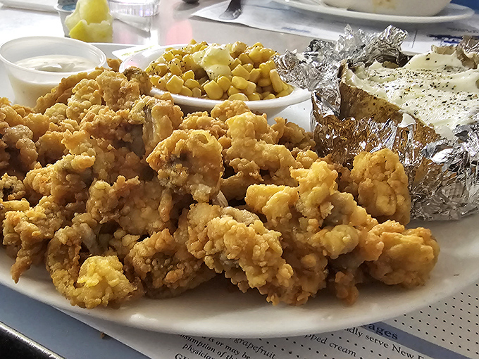 Golden fried clams piled so high they're practically defying gravity, served with sides that complete this coastal Maine masterpiece.