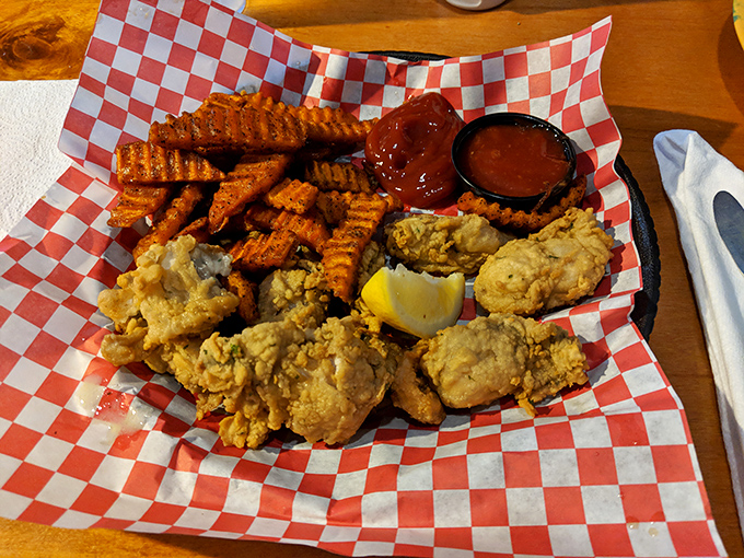 Golden-fried treasures nestled on a red-checkered throne. These crispy morsels make a compelling case for moving Cincinnati to the coastline.
