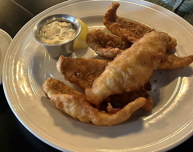 Golden-fried perch that shatters with each bite, paired with homemade tartar sauce that could make cardboard taste delicious.