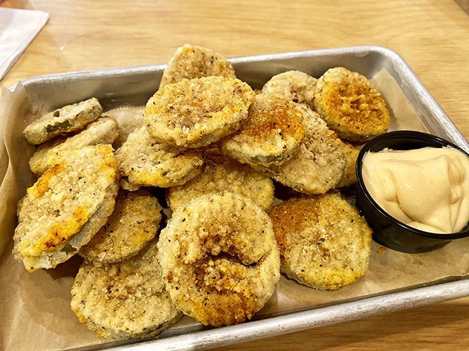 Fried pickles: proof that anything becomes magical when battered and fried. These golden discs deliver the perfect tangy crunch between bites of barbecue.