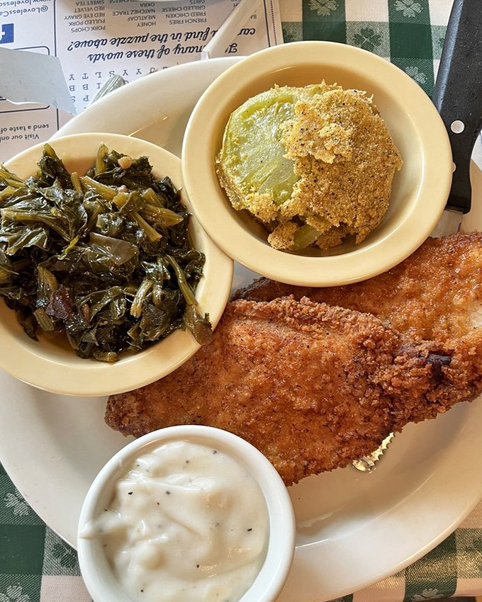 Those collard greens have clearly been simmering since yesterday, and that fried tomato? It's wearing a cornmeal jacket tailored by someone who cares.