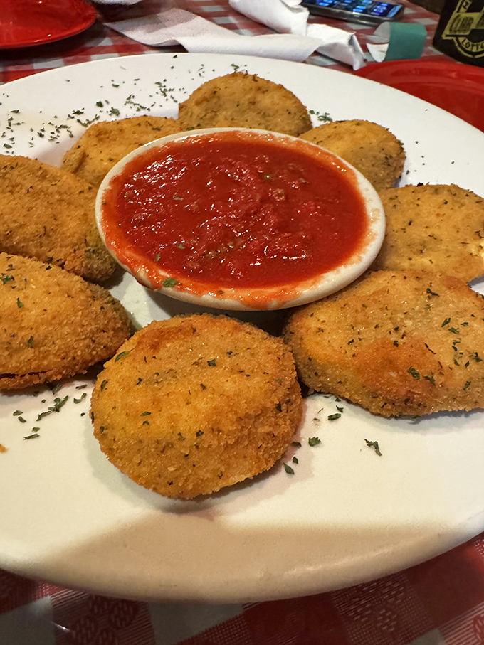 Golden-fried ravioli surrounding marinara like devoted followers around their leader. A crispy prelude to pizza paradise.