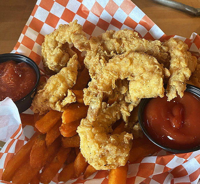 Golden-fried shrimp and sweet potato fries &ndash; proof that sometimes the simplest pleasures come in checkered paper boats.