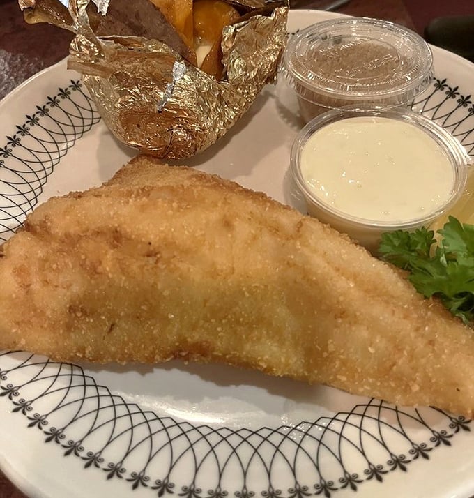 Golden-fried walleye that shatters with each bite, paired with a baked potato wrapped like a precious gift. Minnesota on a plate.