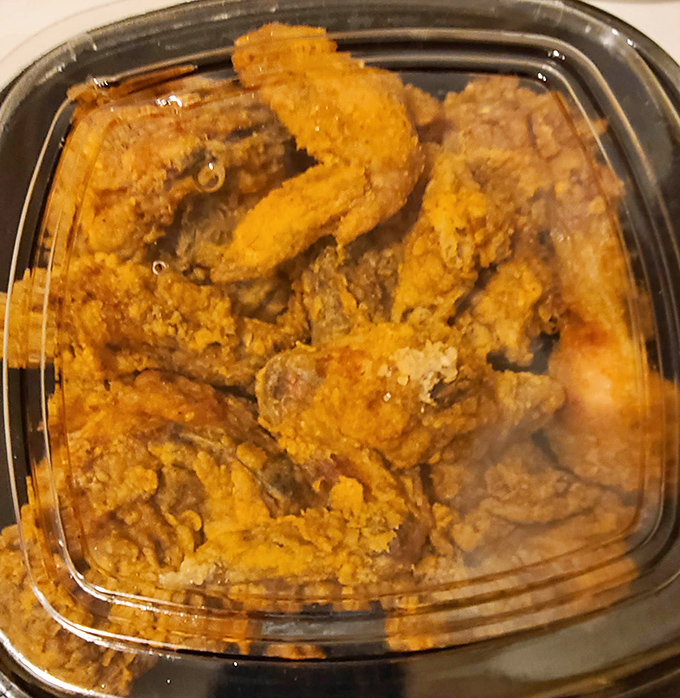 Golden-fried chicken wings that crunch like autumn leaves, packed in a container that says "Yes, you should absolutely order these."