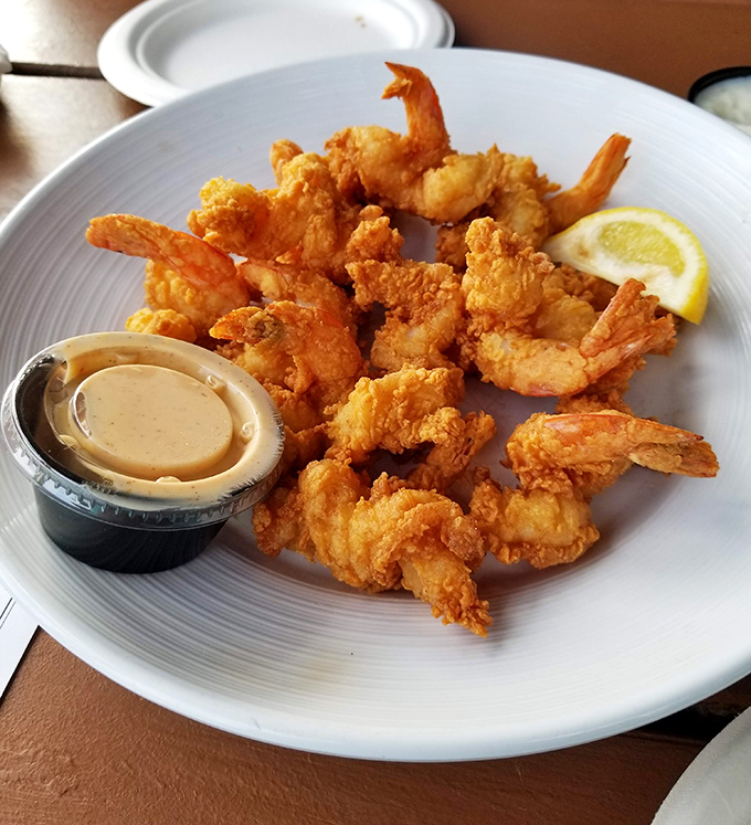 Golden-fried shrimp that snap between your teeth like tiny fireworks of flavor, with dipping sauce standing by for backup.