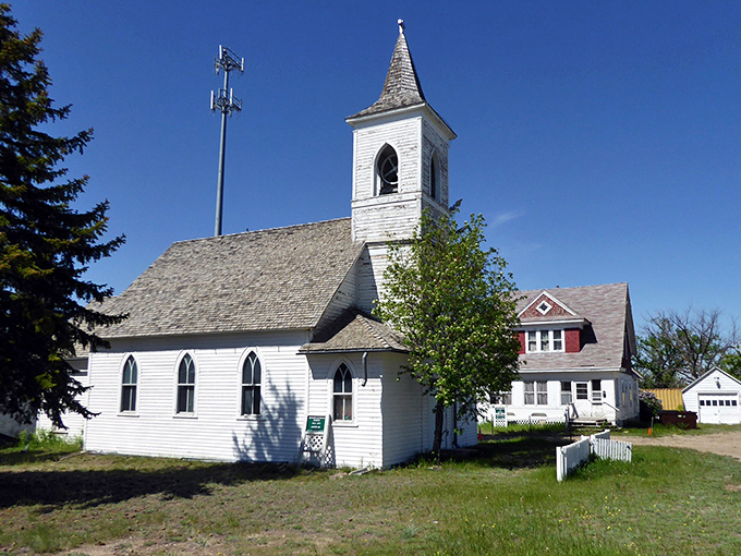 This charming white church, with its elegant steeple reaching skyward, has likely witnessed generations of community gatherings, celebrations, and Sunday best attire.