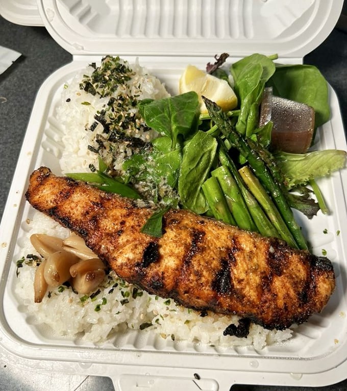 Salmon gets the royal treatment with perfect grill marks, garlic, and a bed of rice. The asparagus is just showing off.