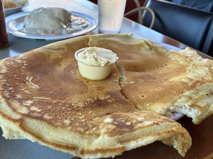 This pancake isn't just big &ndash; it's the size of a hubcap with butter melting into its golden surface like a sunrise over the Arizona desert.