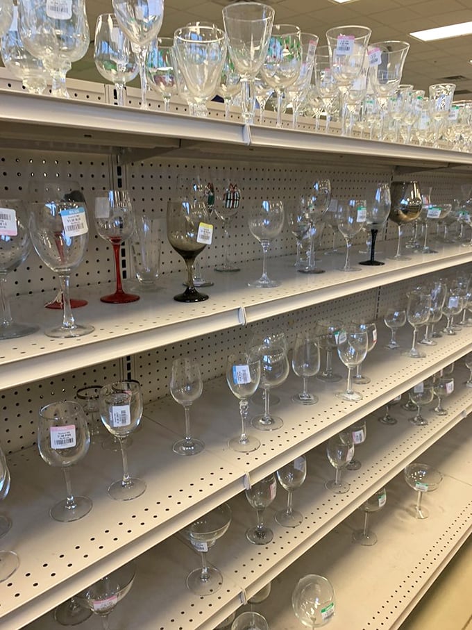 Crystal kingdom! Wine glasses of every shape and size sparkle under fluorescent lights, ready to elevate your Tuesday night boxed wine.