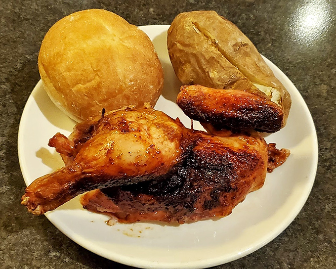Glazed chicken that glistens with promise alongside a golden roll and baked potato&mdash;comfort food that hugs your soul from the inside out.