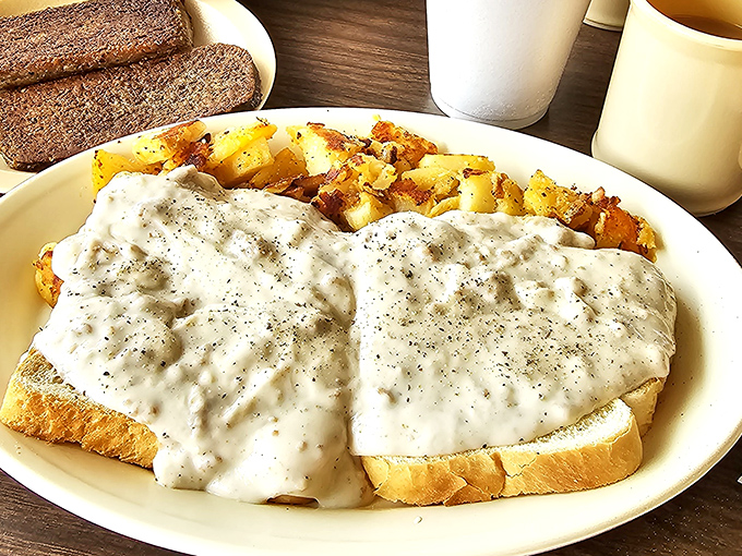 Creamy sausage gravy cascading over toast like a comfort food waterfall. Cardiologists might frown, but your taste buds are giving a standing ovation.