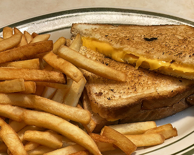 Grilled cheese perfection that would make Marcel Proust weep with nostalgia. Golden, buttery, and melty&mdash;comfort defined on a classic diner plate.