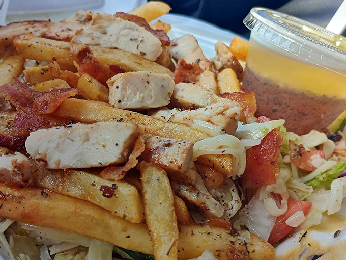 A mountain of protein paradise &ndash; grilled chicken, bacon, and fries sharing a plate with fresh veggies. Diet plans surrender at the sight of this masterpiece.