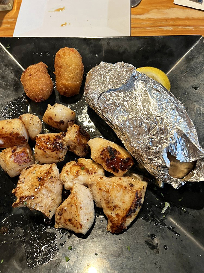 Blackened grouper cheeks and scallops &ndash; proof that sometimes the less obvious seafood choices yield the most memorable meals. That baked potato's just along for the ride.