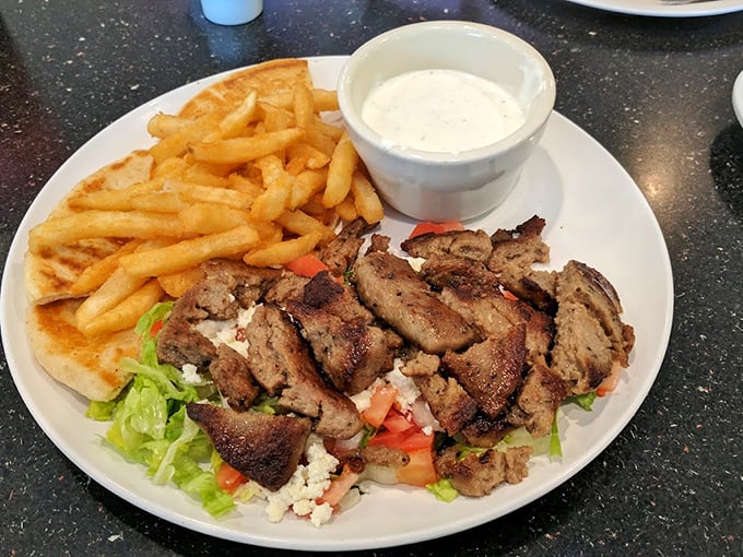 This isn't just a gyro platter; it's a Mediterranean vacation for your taste buds, complete with seasoned meat and golden fries.