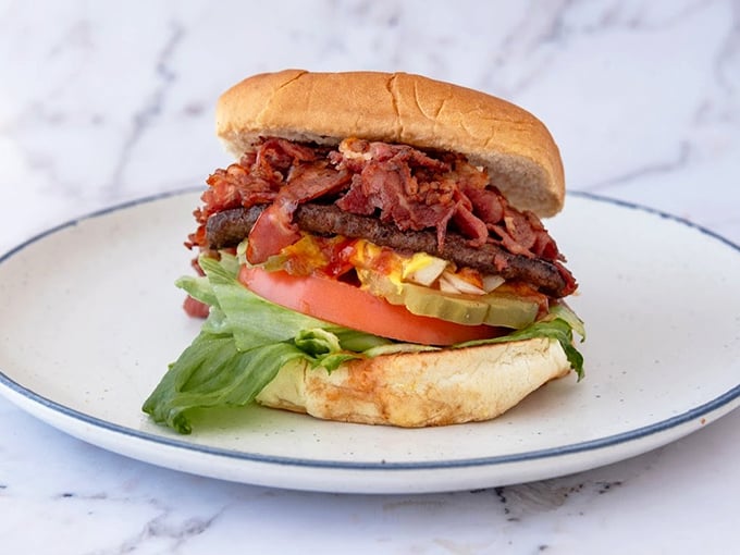 This isn't just a burger; it's architectural perfection. The careful layering of ingredients creates a skyscraper of flavor that demands to be admired before demolished.