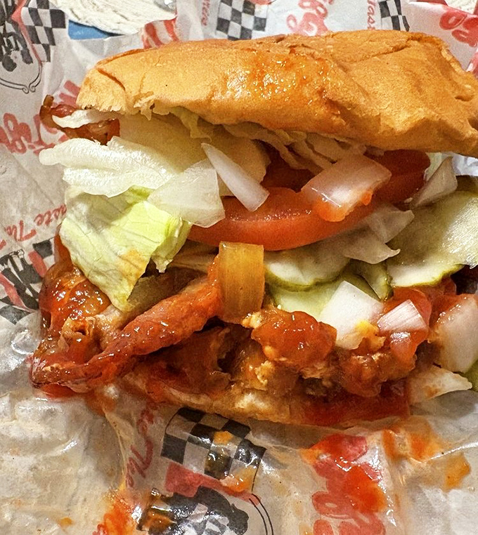 The classic American burger, served on a pillow-soft bun with fresh lettuce, waiting patiently for its Instagram moment before disappearing in five blissful bites.