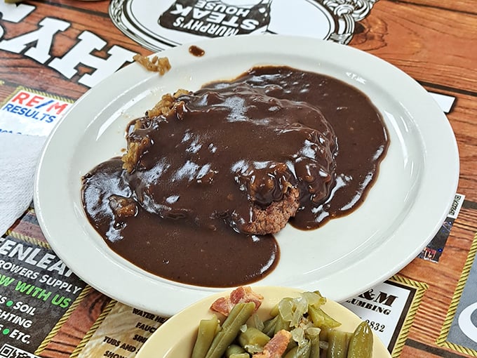 The hamburger steak doesn't just swim in gravy&mdash;it performs synchronized swimming routines in it. Those green beans on the side? They've clearly met a ham hock.