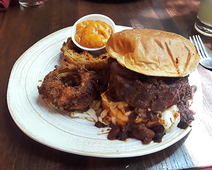 A burger so substantial it deserves its own zip code. That onion ring perched on top isn't garnish&mdash;it's the crown jewel.