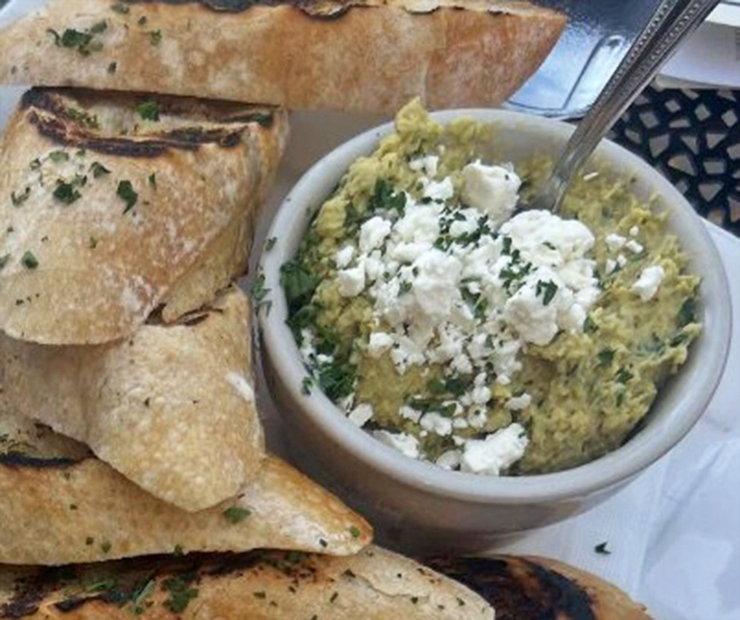 This isn't just hummus &ndash; it's a creamy canvas of chickpea goodness topped with feta, served with perfectly charred flatbread for dipping adventures.