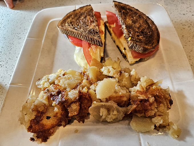 A grilled sandwich that's achieved perfect harmony with those home fries&mdash;crispy on the outside, tender within. The potato whisperer has spoken.