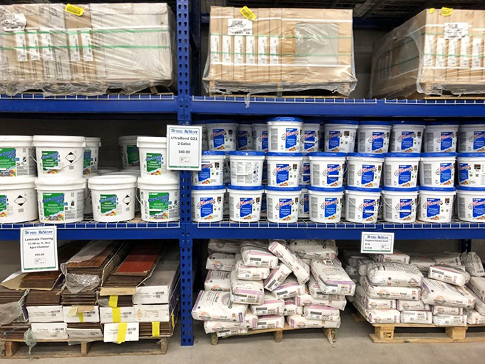 The building materials section: where DIY dreams begin and wallets breathe sighs of relief. Those buckets of paint hold potential transformations at a fraction of retail.