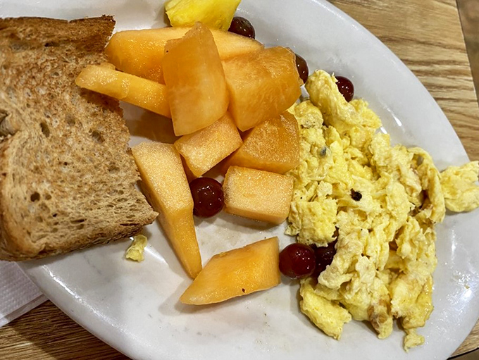 Simple pleasures done right: scrambled eggs, fresh cantaloupe, and toast. Sometimes breakfast doesn't need to be complicated to be extraordinary.