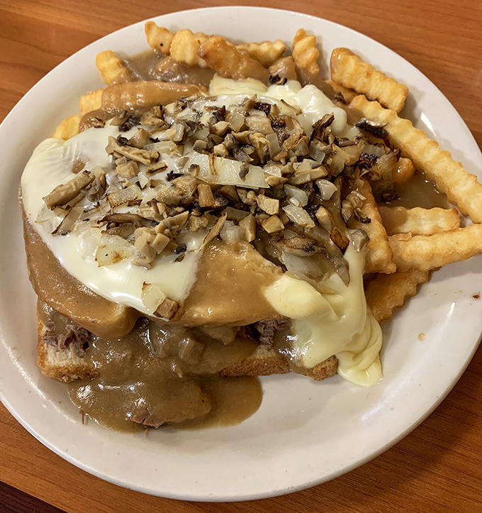 The hot beef sandwich&mdash;where gravy isn't just a condiment but a philosophy, smothering fries that never stood a chance of remaining crispy.