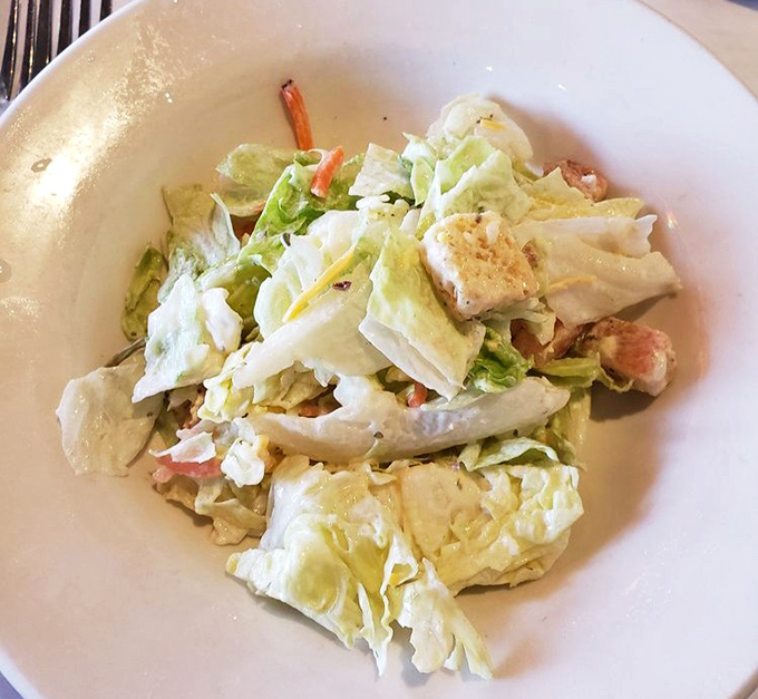 Even the house salad gets the royal treatment here—fresh, crisp, and generous enough to make you momentarily forget you came for the steak.