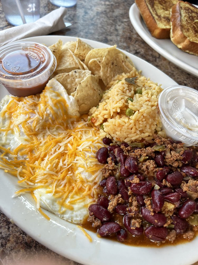 Huevos rancheros with a side of everything wonderful. That sauce isn't just red, it's a flavor explosion waiting to happen.