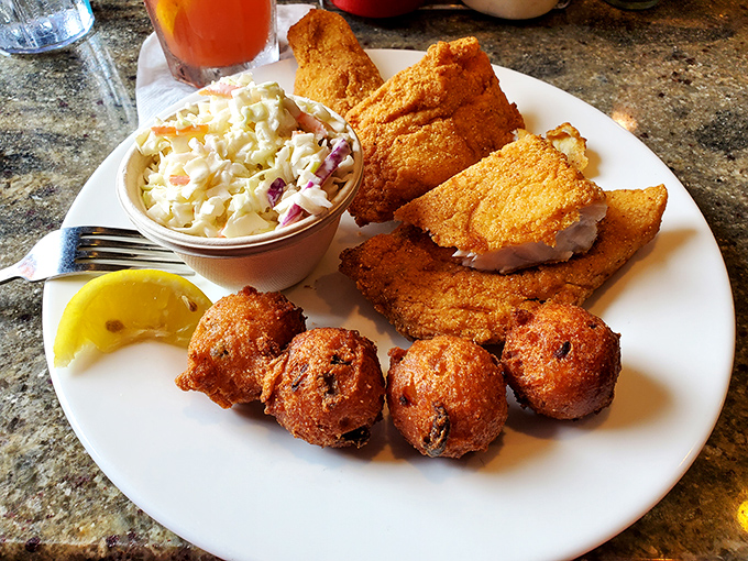 Golden hushpuppies that would make your Southern grandmother weep with joy, alongside perfectly fried fish that practically whispers "you're on vacation now."
